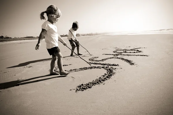 Kids writing in sand Stock Photo by ©Daxiao_Productions 28404445