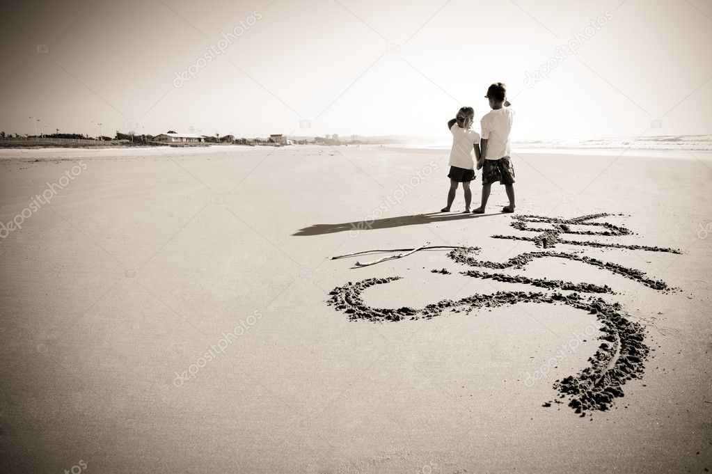 Kids writing in sand Stock Photo by ©Daxiao_Productions 28404445