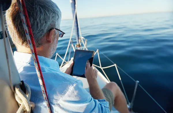 Tablet computer on boat - Stock Image - Everypixel
