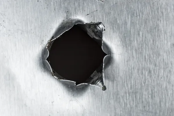 Bullet hole in sheet metal - Stock Image - Everypixel