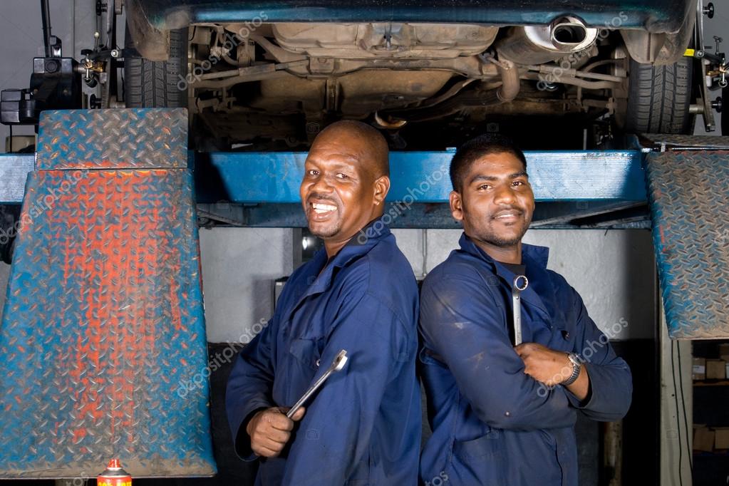 Two african american mechanics inside garage — Stock Photo ...