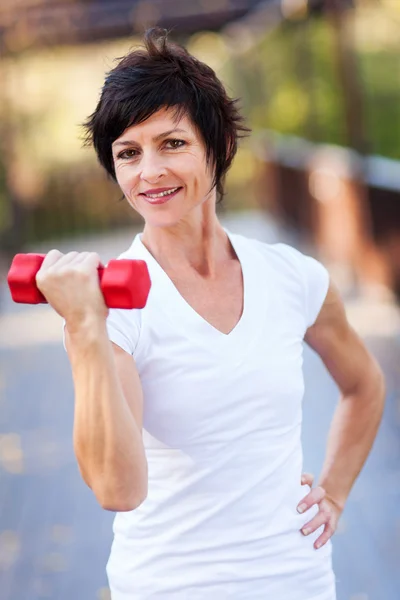 Happy middle aged woman exercise with dumbbells - Stock Image - Everypixel