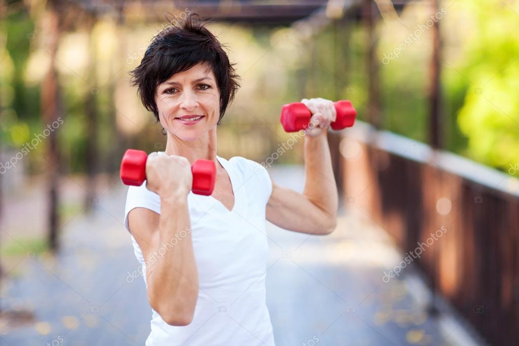 Active middle aged woman workout with dumbbells — Stock Photo ...