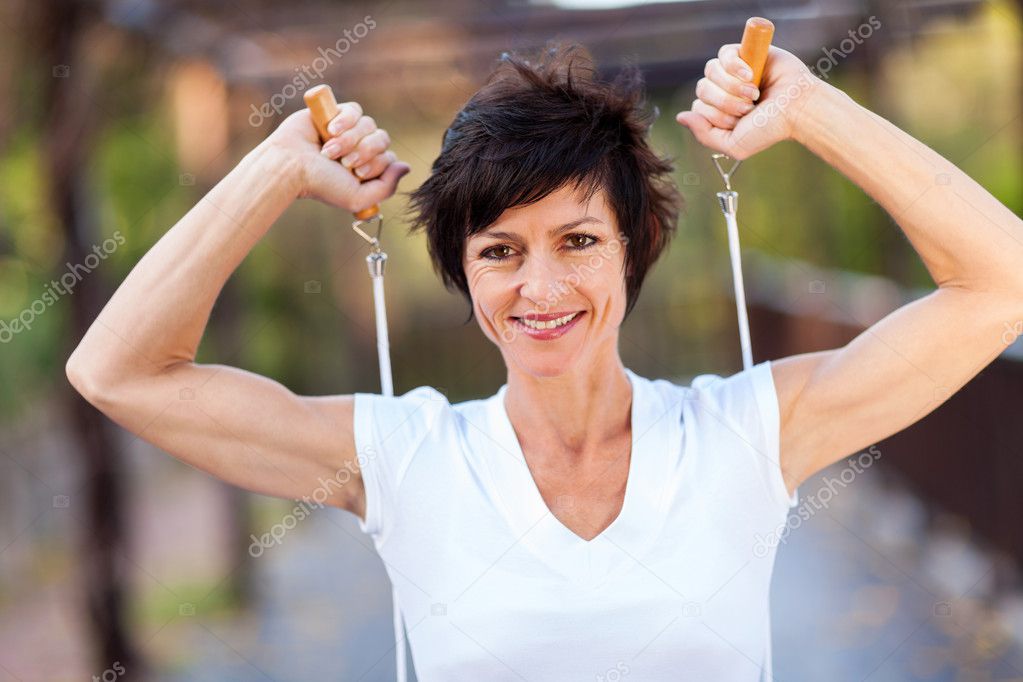 Happy middle aged woman workout with jumping rope Stock Photo by ...