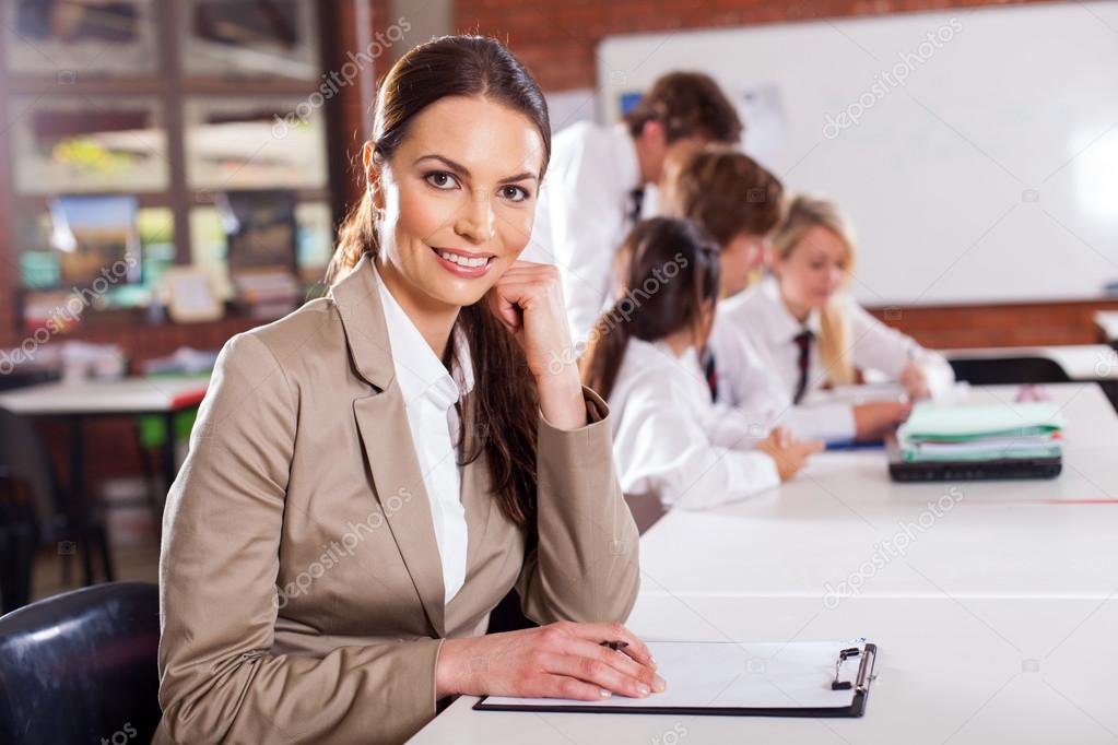 Attractive female school teacher in classroom — Stock Photo ...