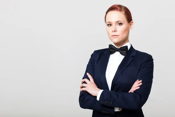 Pretty woman in suit with bow tie sitting on chair Stock Photo by ...