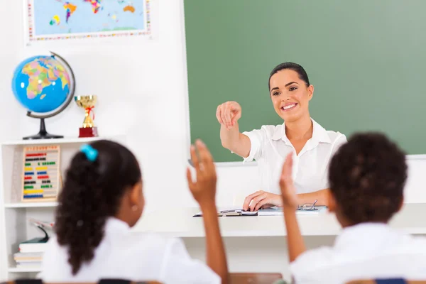 Elementary teacher calling students in classroom - Stock Image - Everypixel