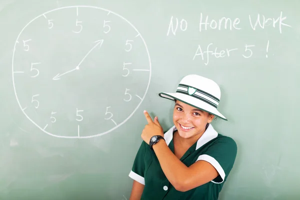 high school student pointing at the watch drawn on the chalkboar ...