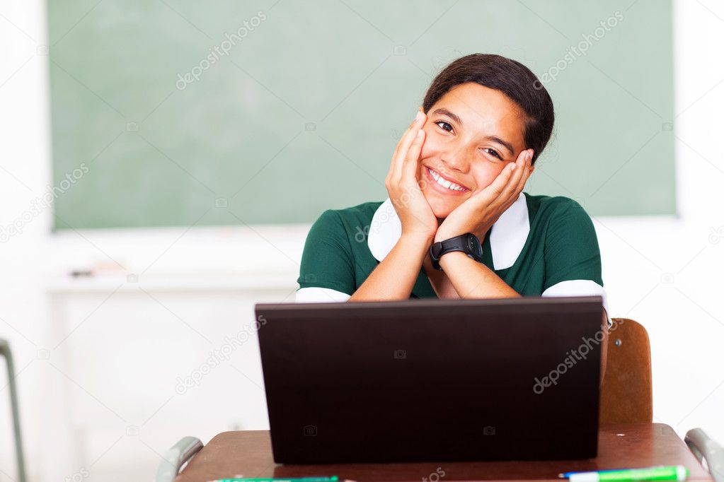 Smiling teen middle school girl using computer — Stock Photo ...