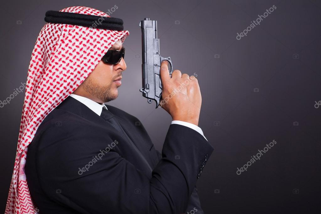 Arabic secret detective holding a gun Stock Photo by ©michaeljung 25421769