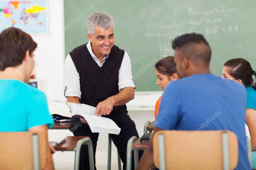 Senior high school teacher teaching in classroom — Stock Photo ...