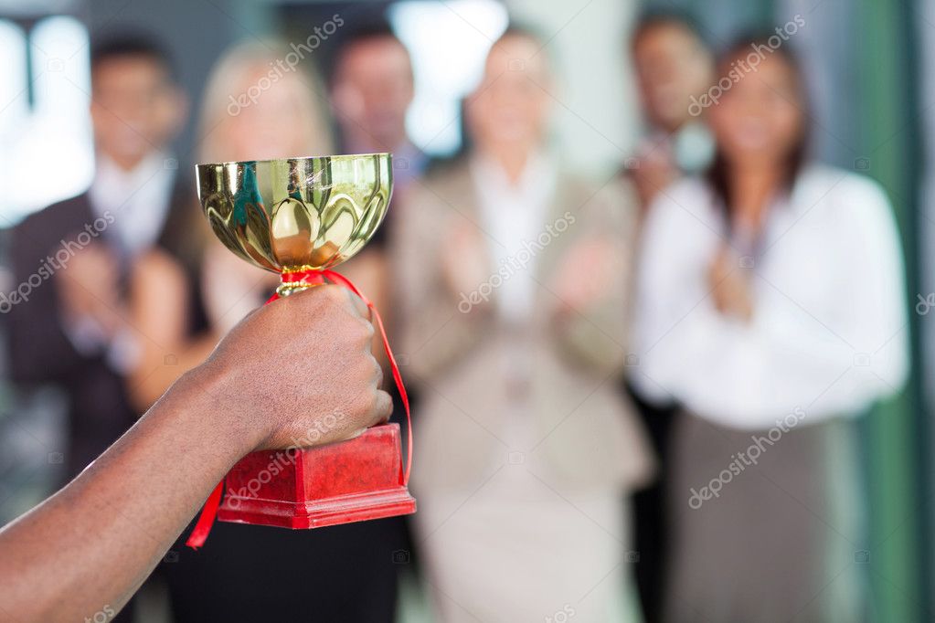 Business team winning a trophy Stock Photo by ©michaeljung 28007099