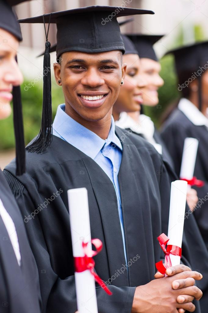 Smiling african graduates standing with classmates — Stock Photo ...