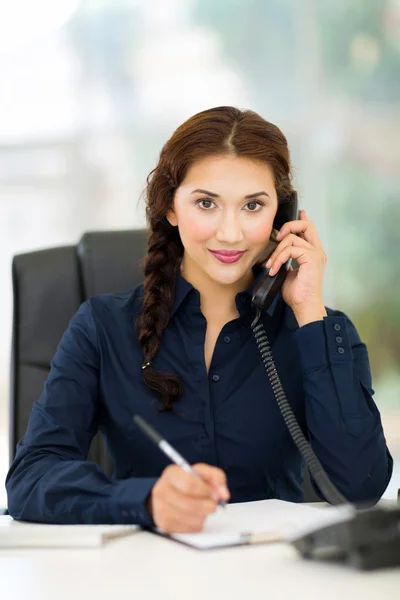 Young office worker talking on landline phone - Stock Image - Everypixel