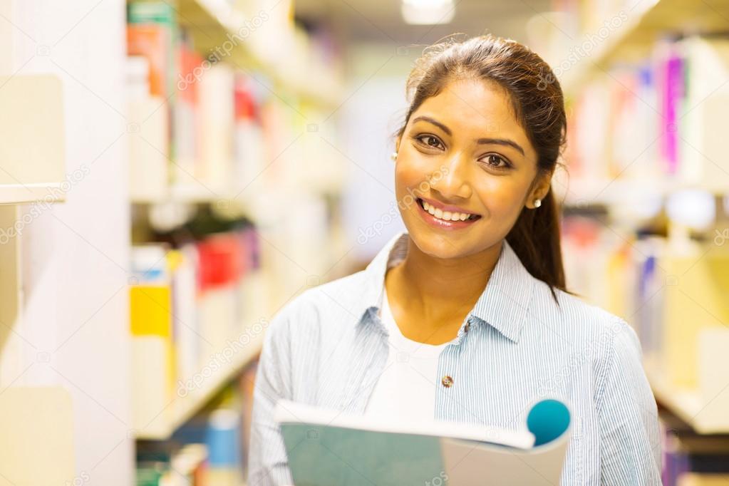 College girl reading book in library — Stock Photo © michaeljung #47157679