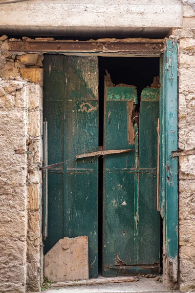 Old worn-out doors in a historic stone house of the 18th-19th centuries ...