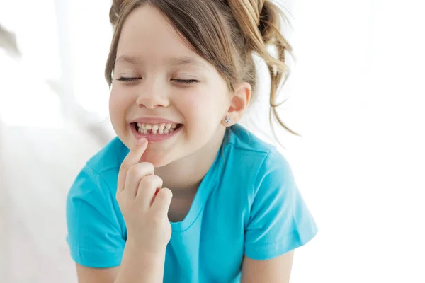 The little girl lost a tooth. Loss of the first tooth in a child ...
