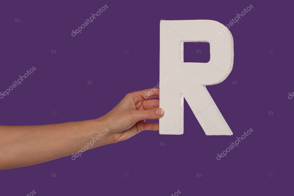 Female hand holding up the letter R from the left — Stock Photo ...
