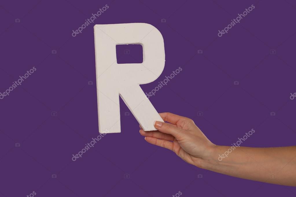 Female hand holding up the letter R from the right Stock Photo by ...