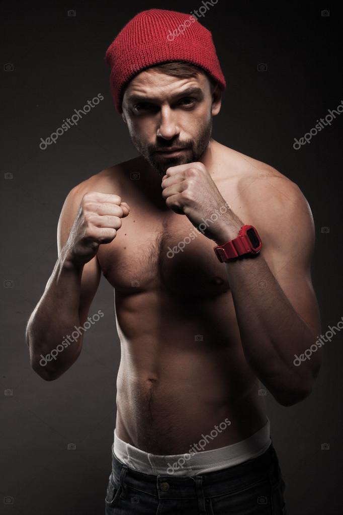 Portrait of a fit young man in an aggressive pose Stock Photo by ...