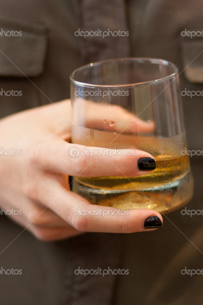 Woman hand holding a whisky glass — Stock Photo © piccaya #33547455