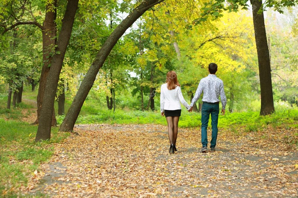 Young couple backside in autumn park — Stock Photo © lenanet #17661647