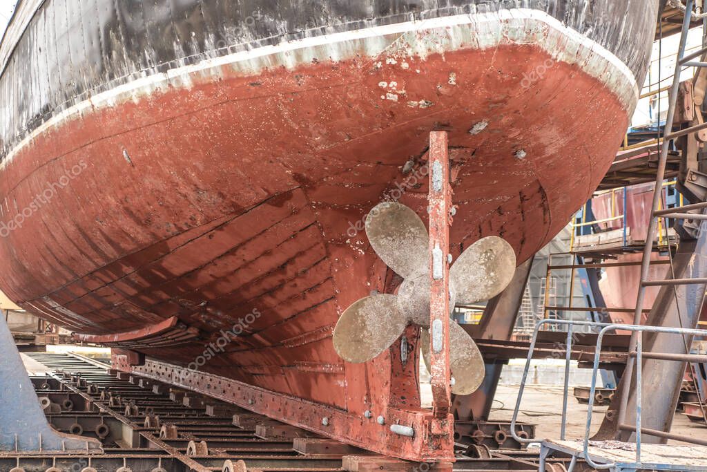 The hull and propeller of a fishing boat during renovation in the port ...