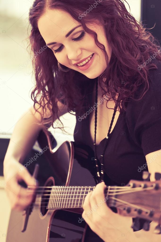 Smiling acoustic guitar player Stock Photo by ©sumners 43146551