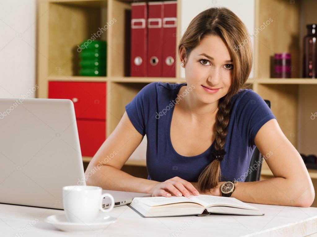 Beautiful woman reading and using a laptop — Stock Photo © sumners ...