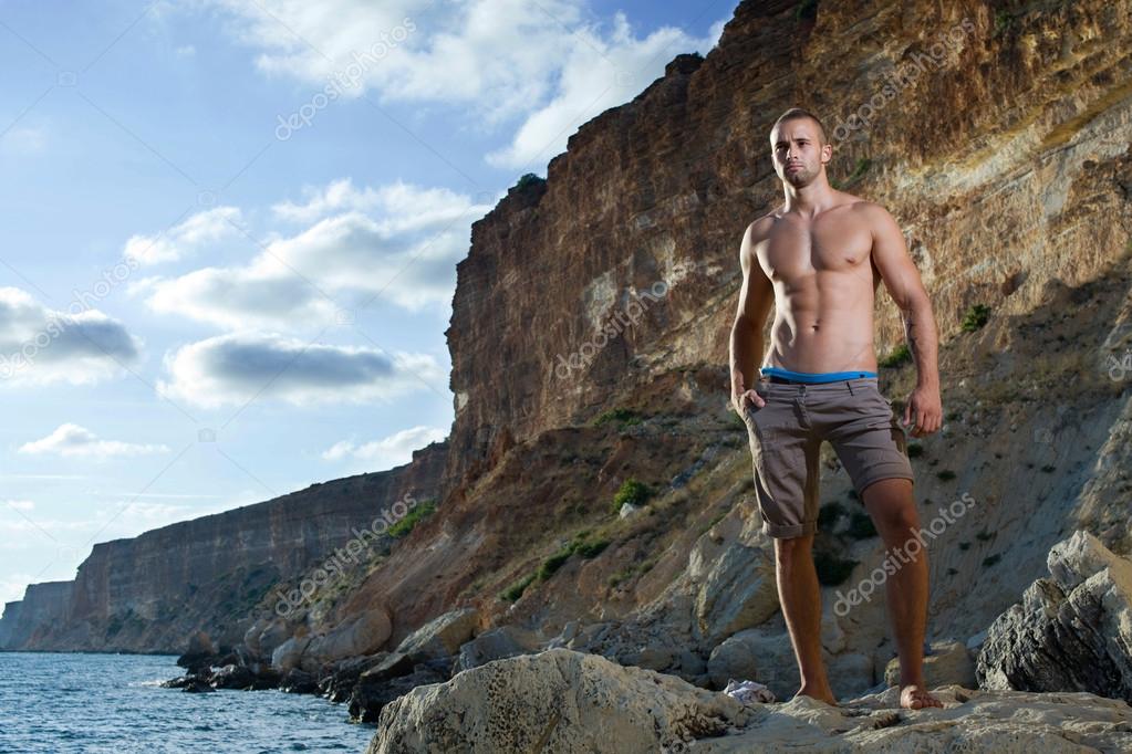 Bodybuilder at the beach Stock Photo by ©arastorguev 30660085