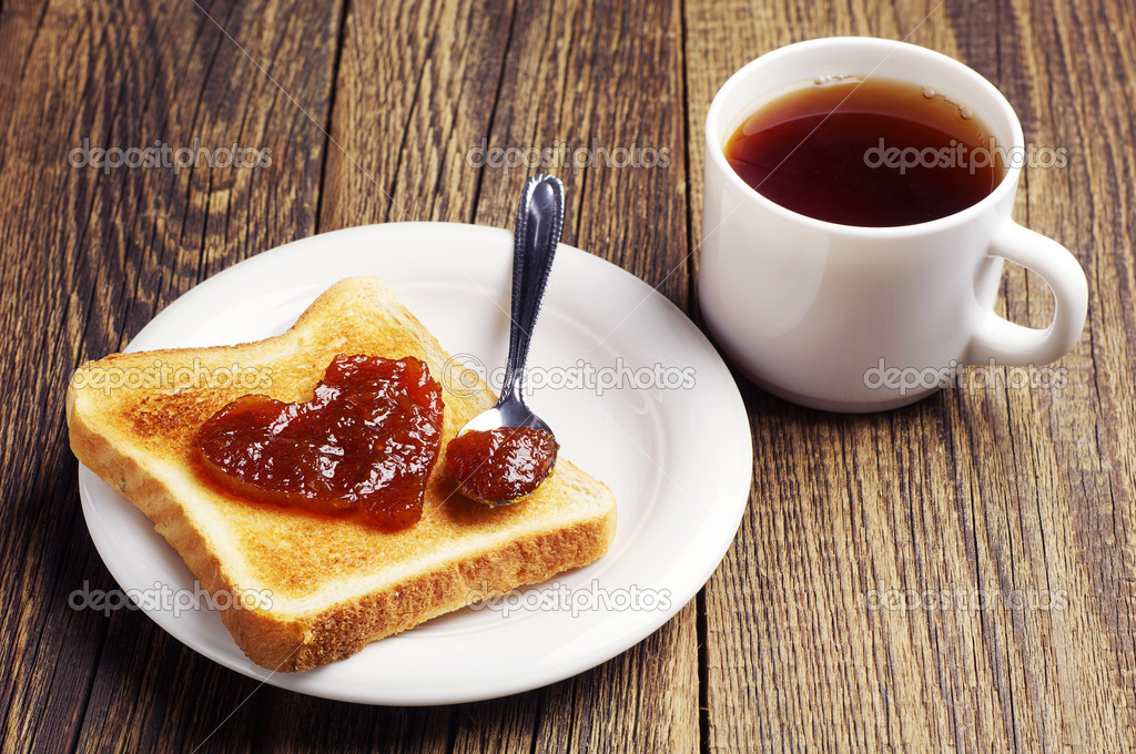 Tea and toast bread with jam in shape of hearts — Stock Photo © Sasajo ...