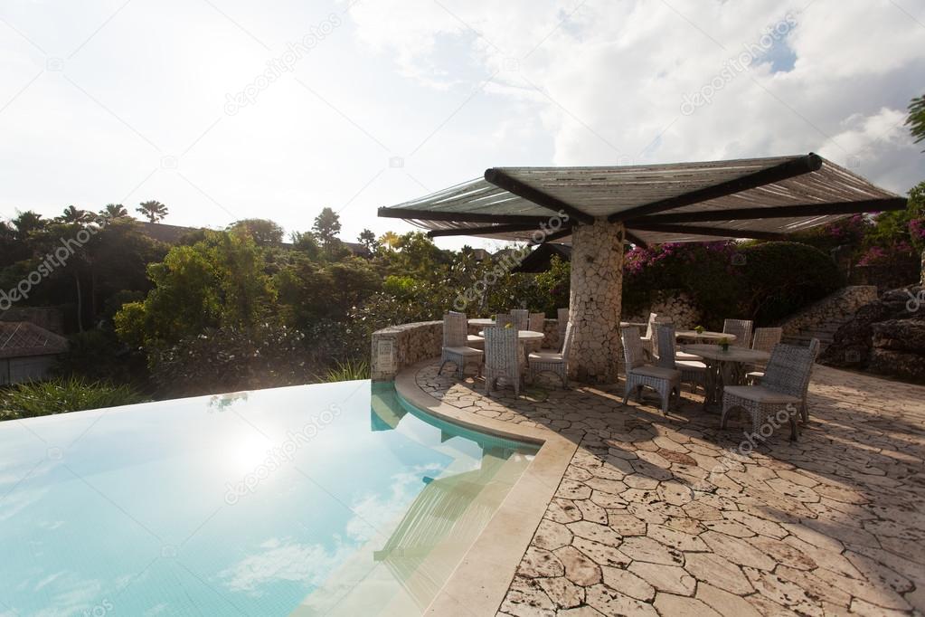 Tropical cafe with swimming pool Stock Photo by ©pavlin 26879645