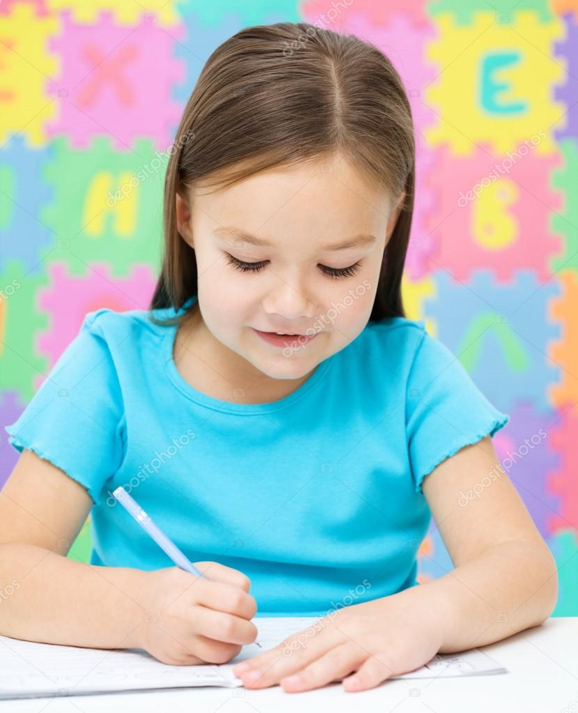 Little girl is writing using a pen — Stock Photo © Kobyakov #18028491