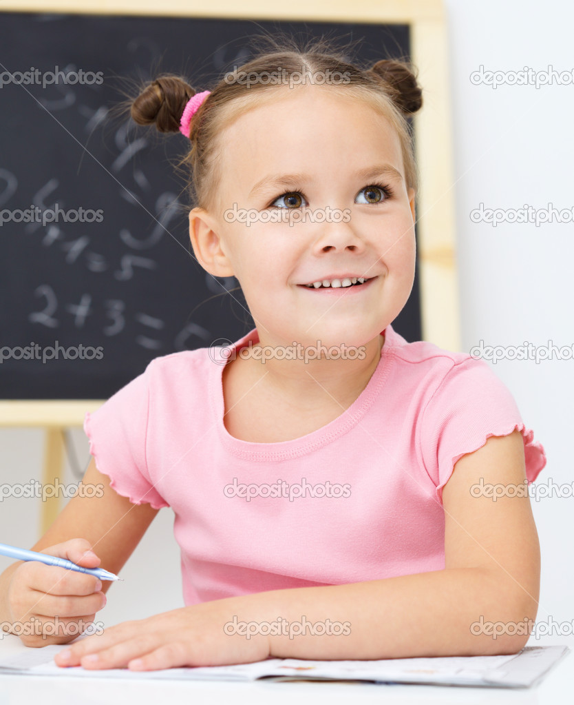 Little girl is writing using a pen Stock Photo by ©Kobyakov 23067576