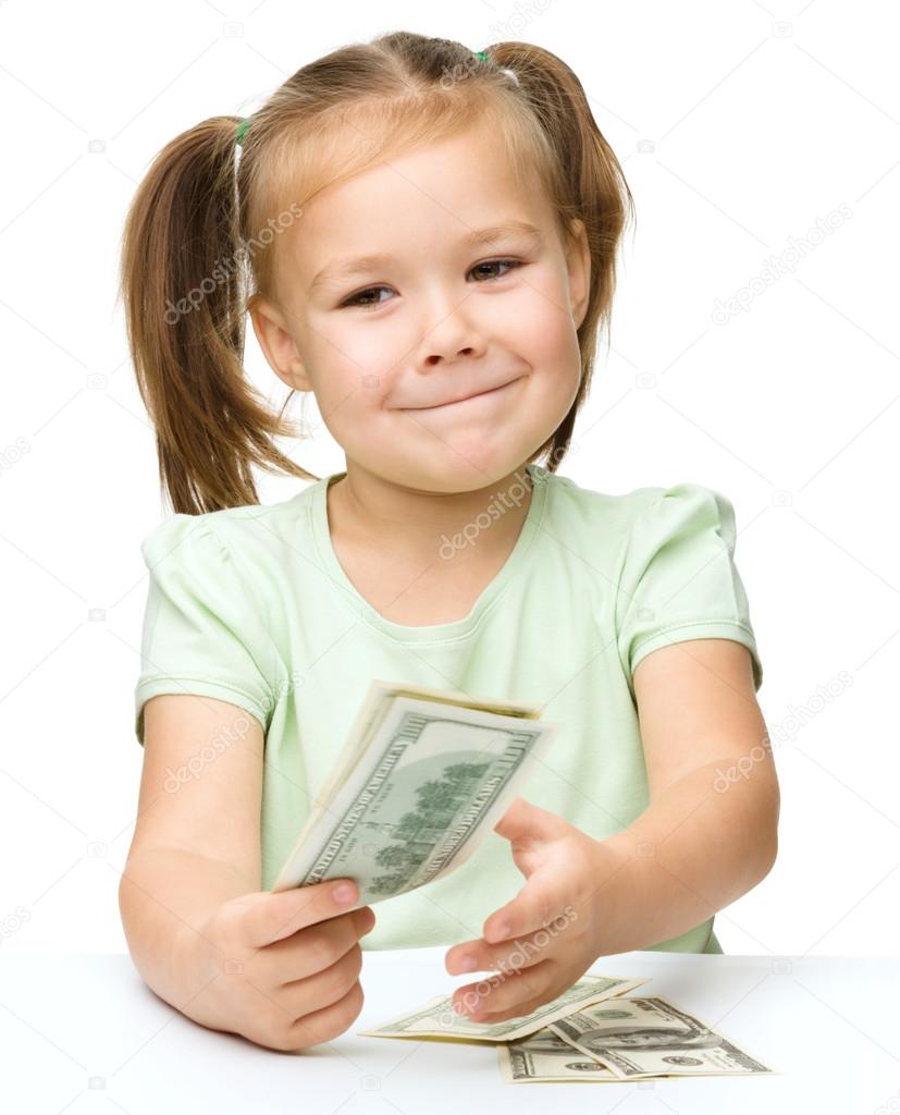 Little girl is counting dollars — Stock Photo © Kobyakov #24551851