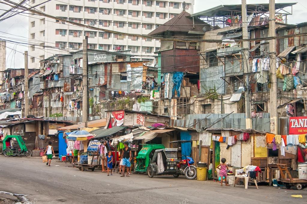 Poor people living in destroyed buildings near the road in Mani – Stock ...