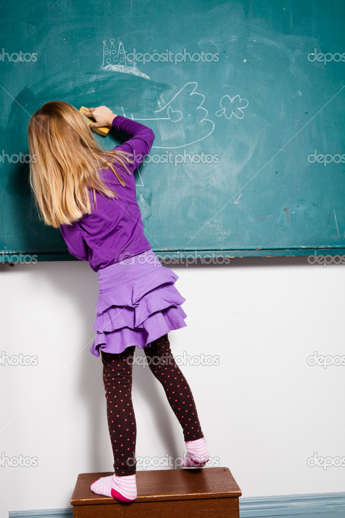 Young girl drawing on chalkboard — Stock Photo © ElinaManninen #18633373