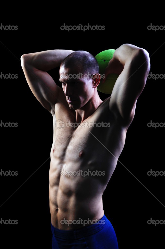 Muscular athlete man exercise on a black background Stock Photo by ...