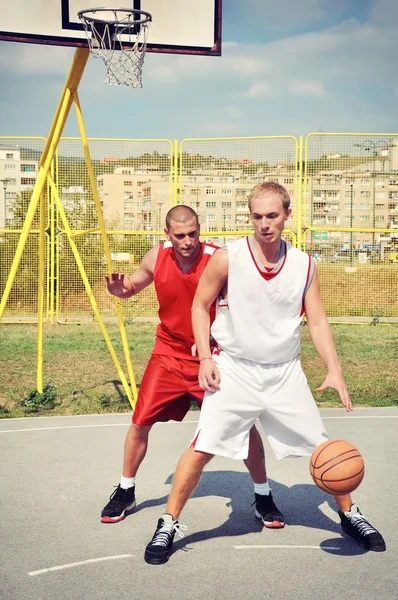 Two basketball players on the court Stock Photo by ©cirkoglu 37564021