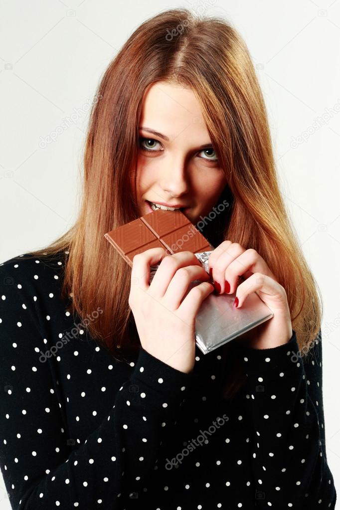 Young beautiful woman eating chocolate Stock Photo by ©Vadymvdrobot ...