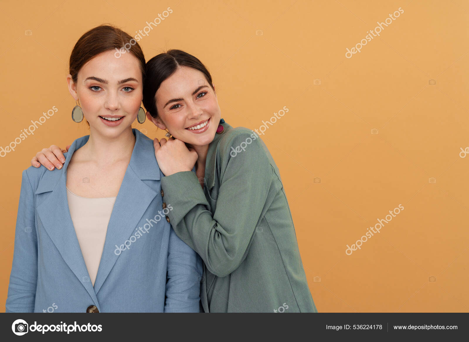 Young Two Women Wearing Jackets Hugging Smiling Camera Isolated Yellow ...