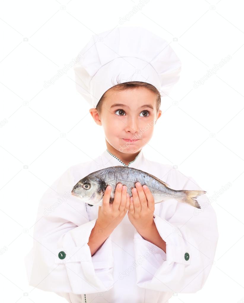 Little boy chef in uniform surprised holding dorado fish — Stock Photo ...
