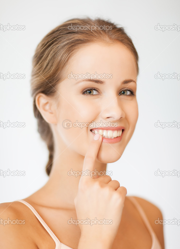 Beautiful woman pointing to teeth Stock Photo by ©Syda_Productions 13738758
