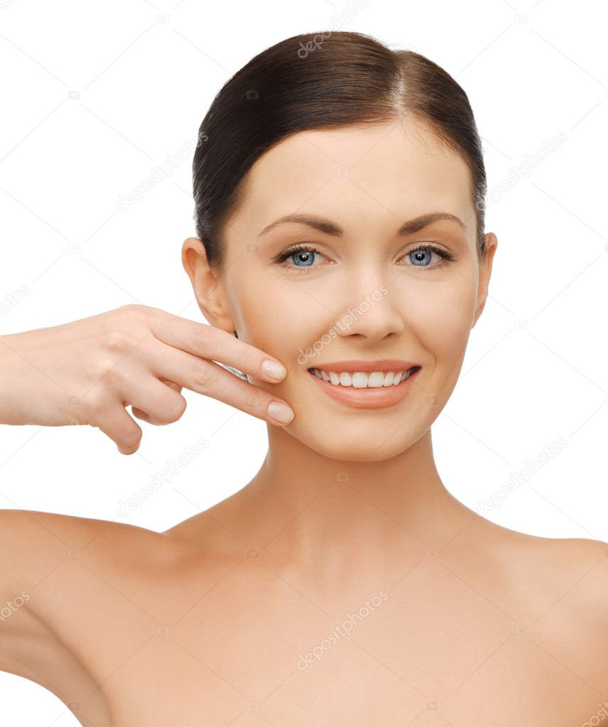 Beautiful woman pointing to cheek — Stock Photo © Syda_Productions #18899143