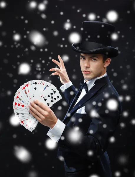 Magician showing trick with playing cards - Stock Image - Everypixel