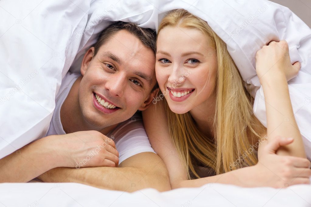 Happy couple sleeping in bed — Stock Photo © Syda_Productions #37405911