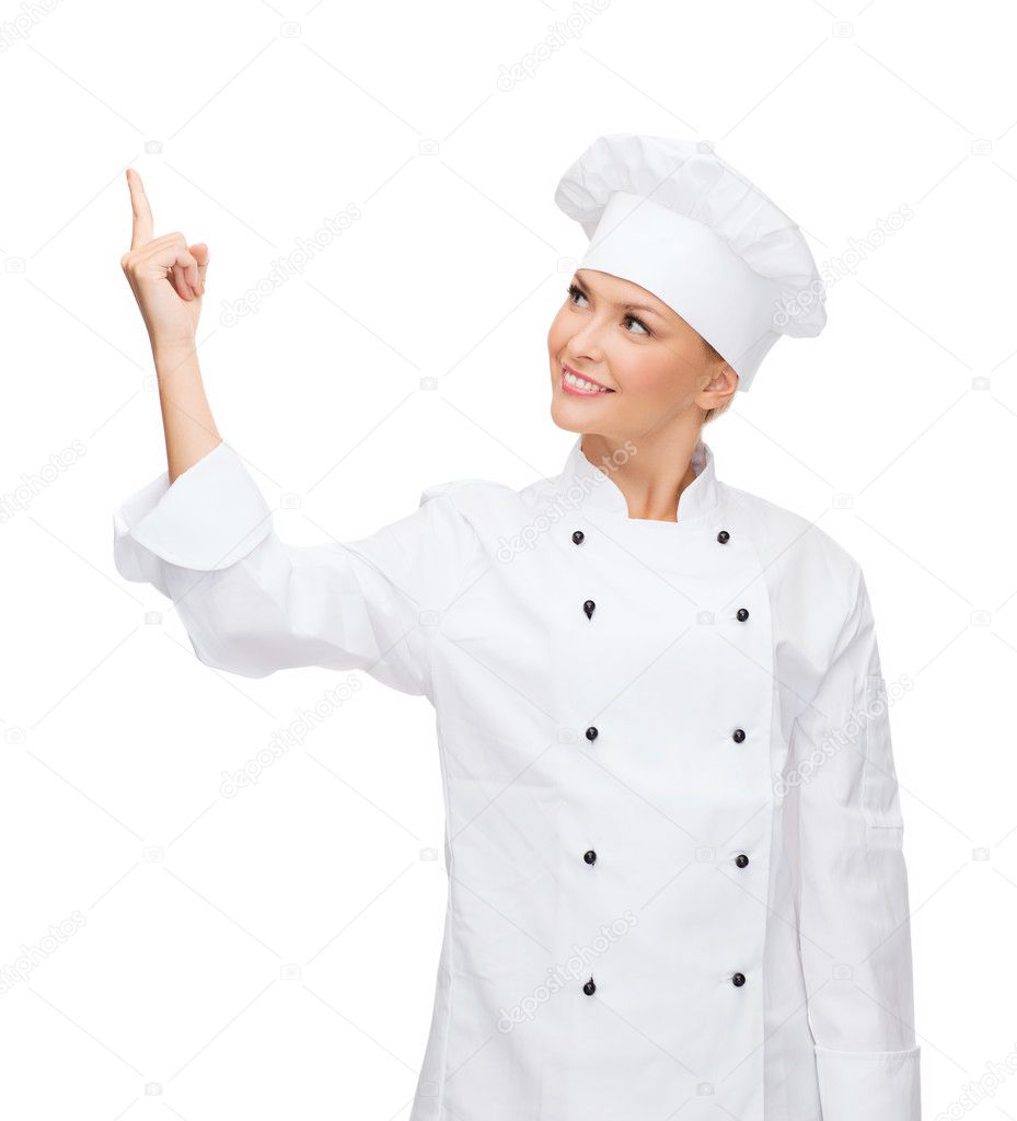 Smiling female chef pointing finger to sonething Stock Photo by ©Syda ...