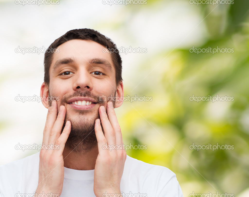 Beautiful smiling man touching his face — Stock Photo © Syda ...