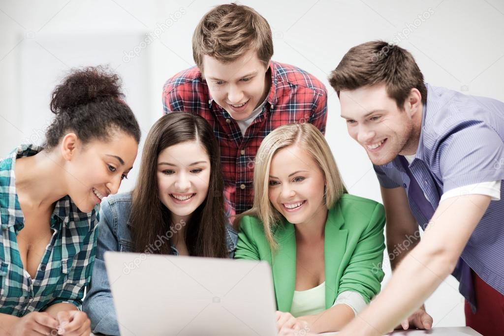 International students looking at laptop at school — Stock Photo © Syda ...