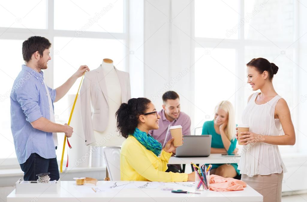 Smiling fashion designers working in office Stock Photo by ©Syda ...